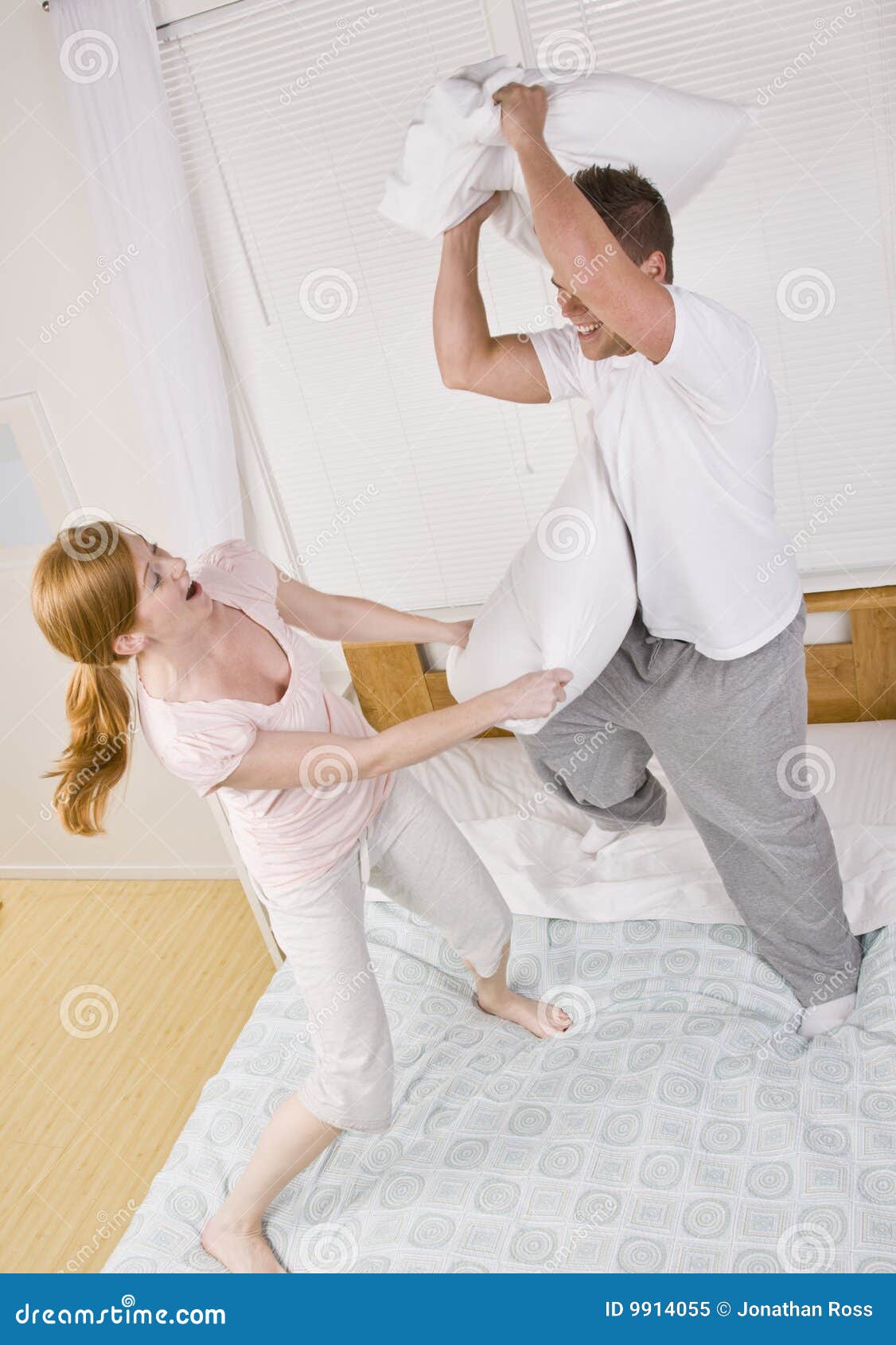 Playful Couple Having a Pillow Fight Stock Image - Image of adult ...