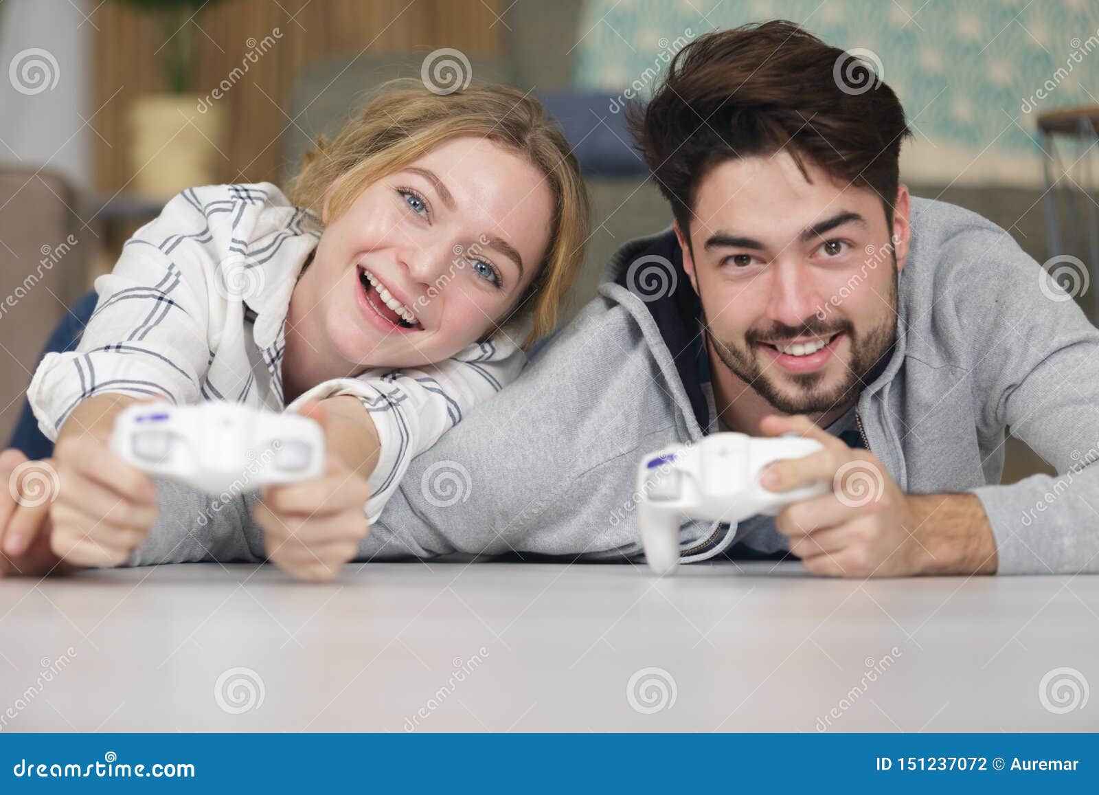 Playful Couple Layed on Floor Playing Computer Game Stock Photo - Image ...