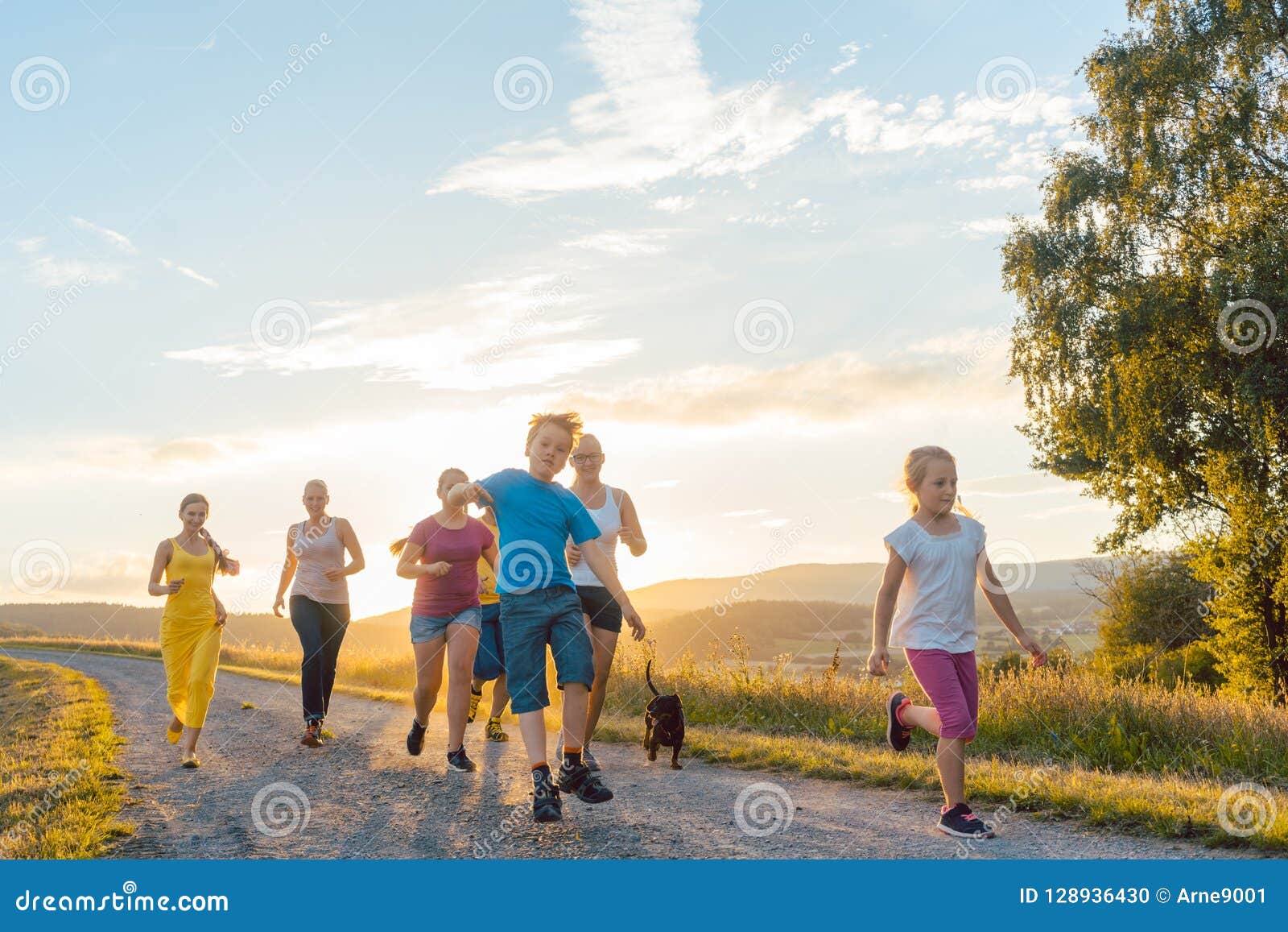 Playful Family Running and Playing on a Path in Summer Landscape Stock ...