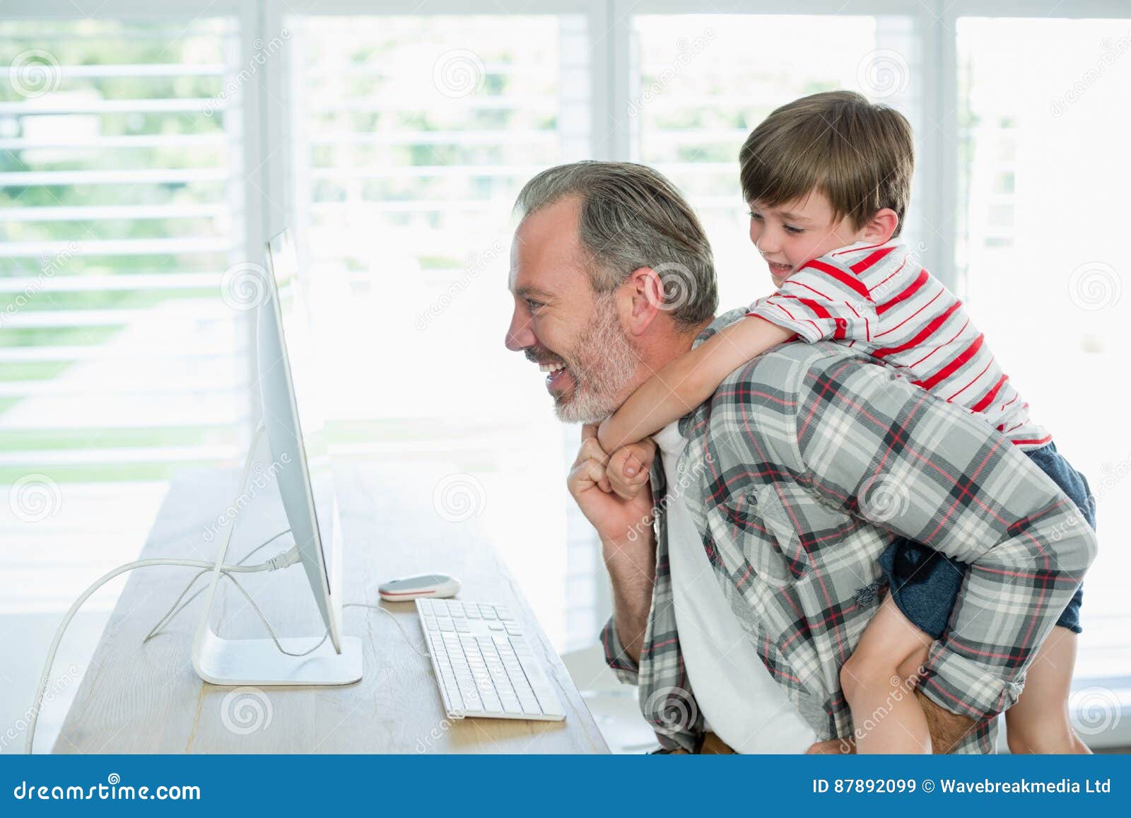 Playful Father and Son Working on Computer at Home Stock Image - Image ...