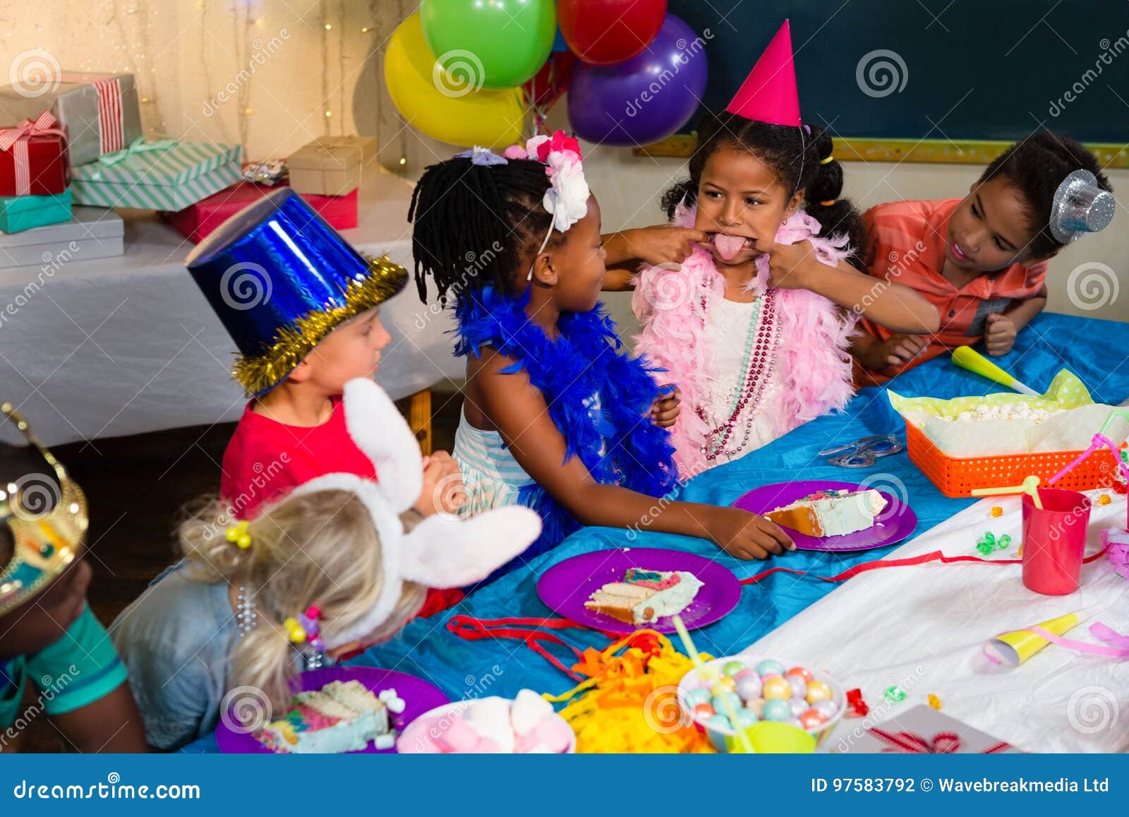 Playful kids at table stock photo. Image of costume, finger - 97583792