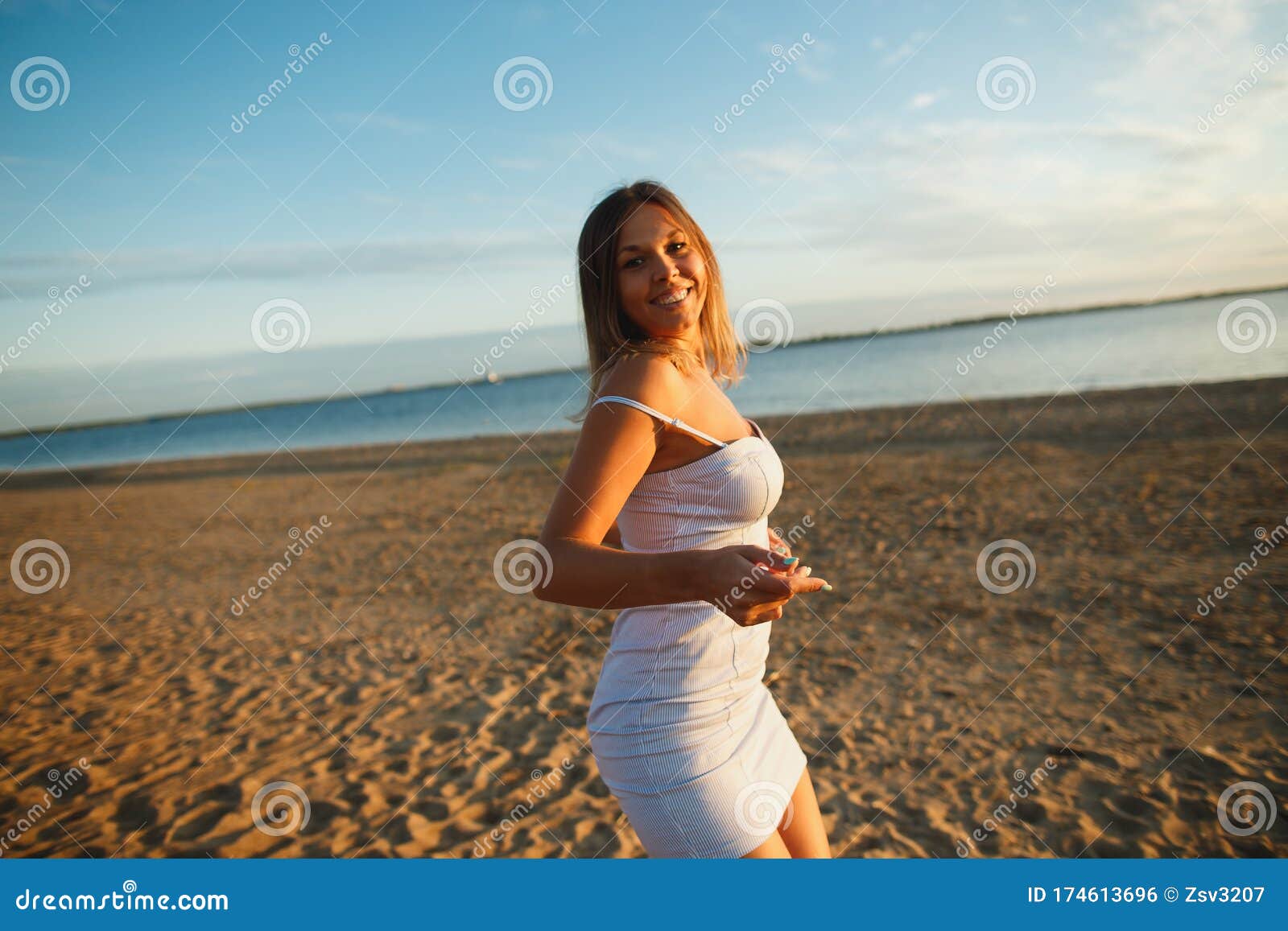 Playful Woman Having Fun On The Beach On The Sunset Cheerful Young