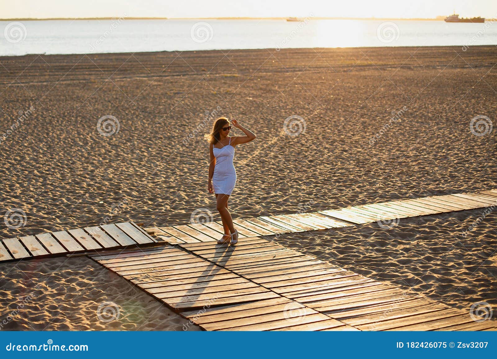Playful Tanned Woman Running On The Beach On The Sunset Cheerful