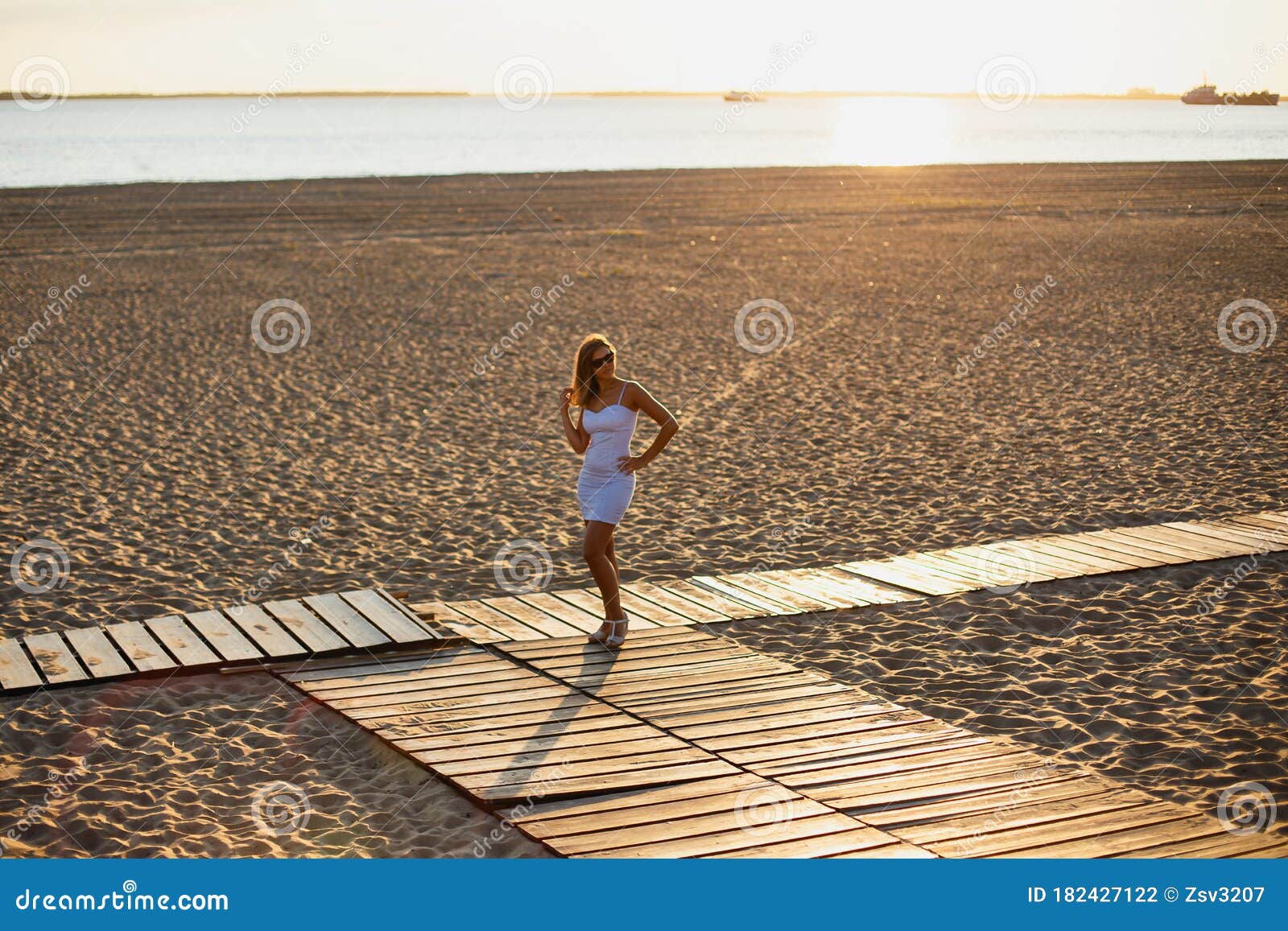 Playful Tanned Woman Running On The Beach On The Sunset Cheerful
