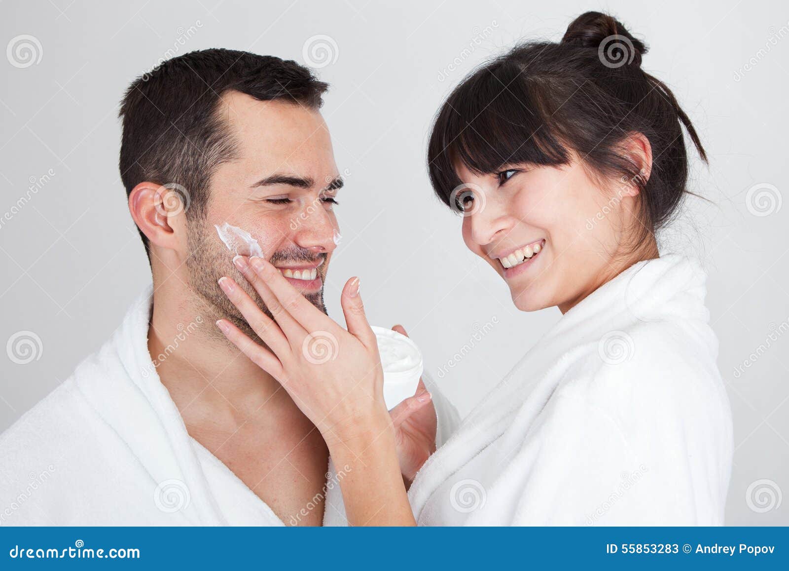 Playful Young Couple Applying Cream Stock Image - Image of cream, human ...