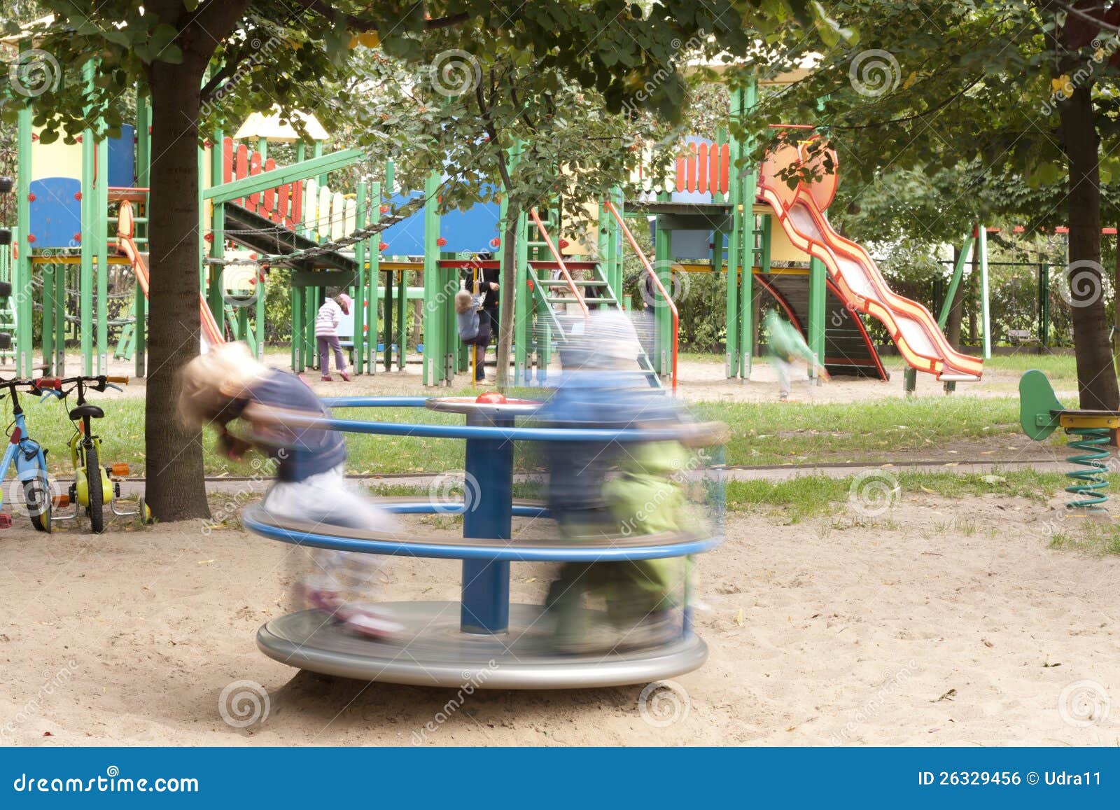 Playground with Kids and Carousel Stock Photo - Image of playtime ...