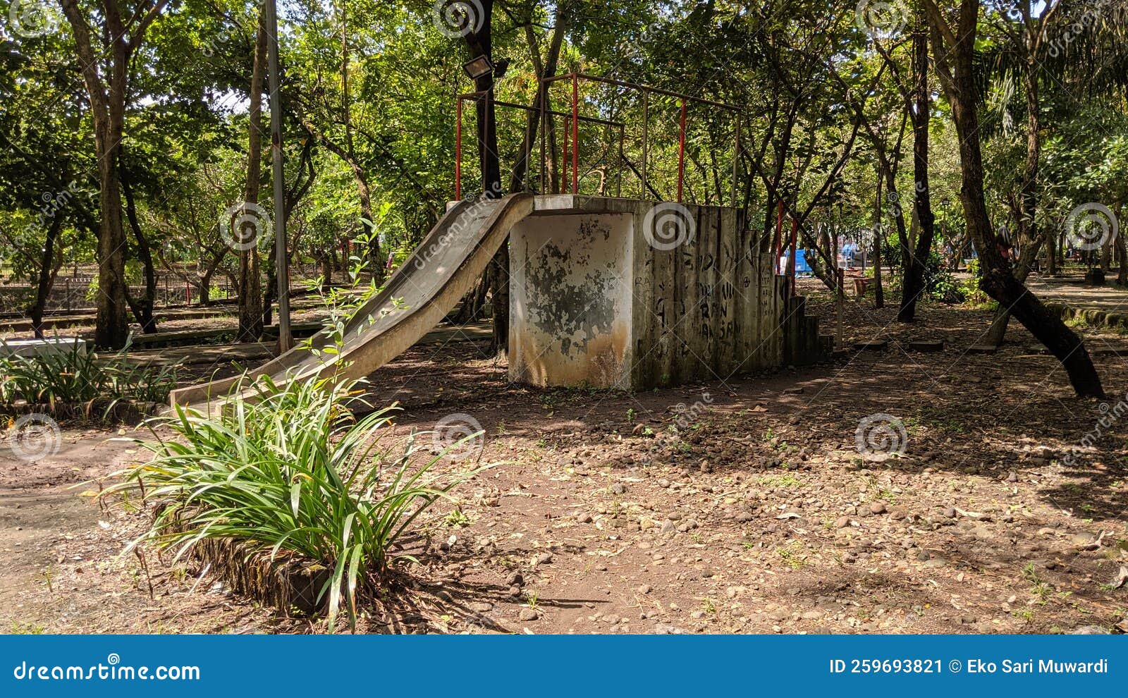 The Playground Slide Made of Cement is Under the Trees Stock Image ...