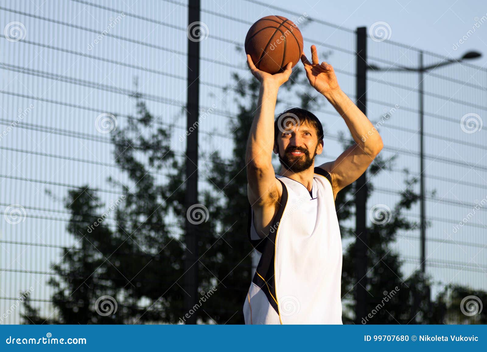 Playing basketball player stock photo. Image of sportsman - 99707680