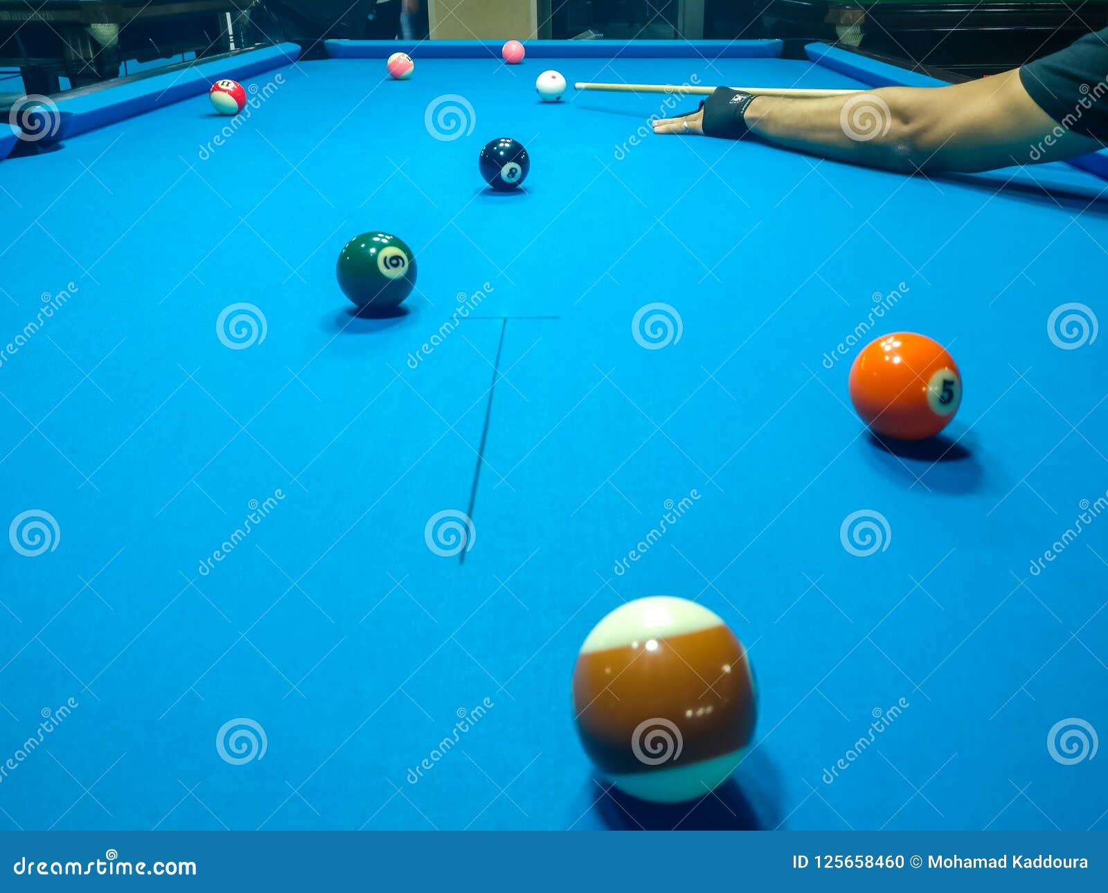 Playing Billiard - a Shot of a Man Playing Billiard on a Blue Pool ...