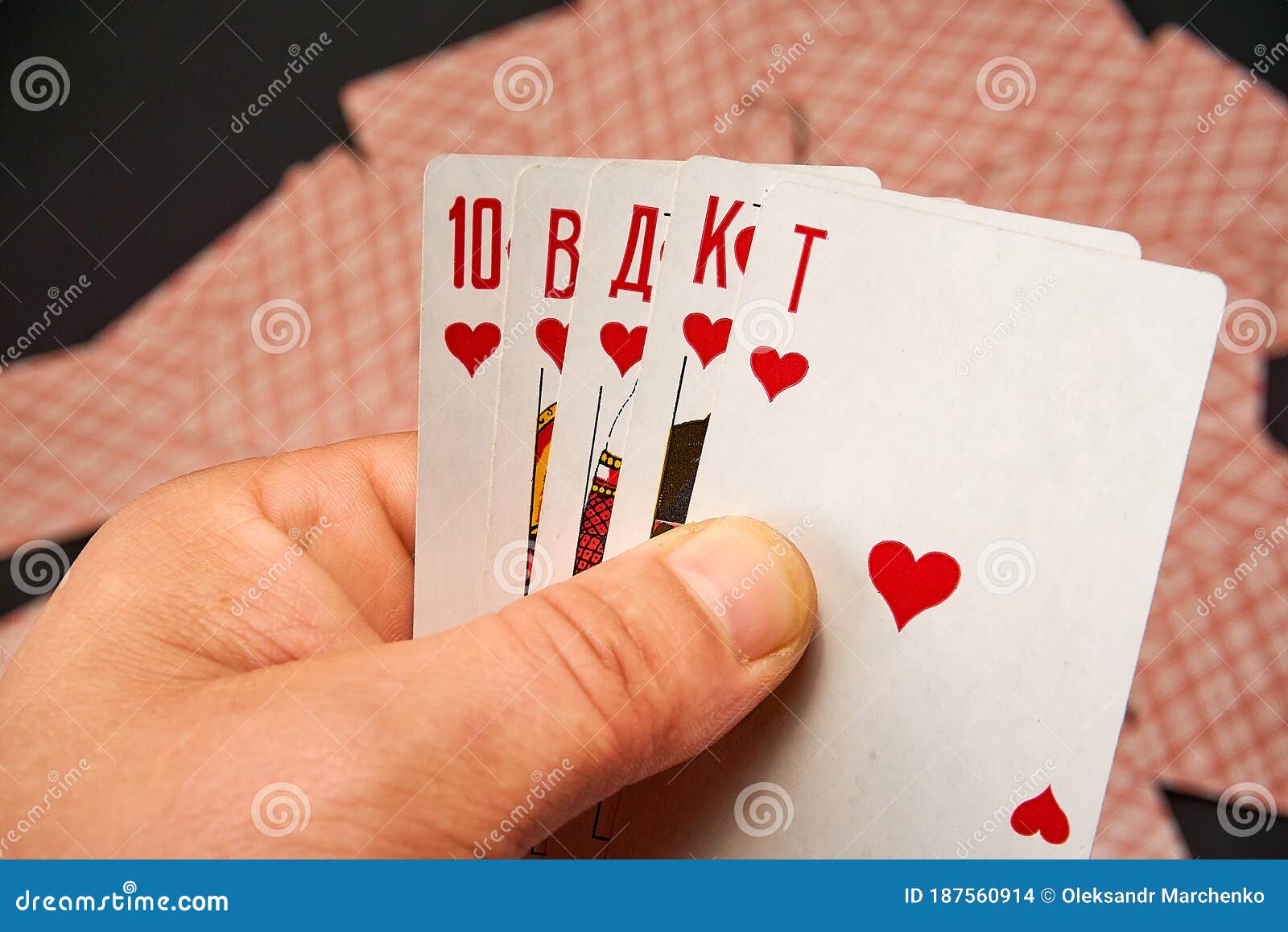 Playing Cards in Hands on a Background of Scattered Inverted Cards ...