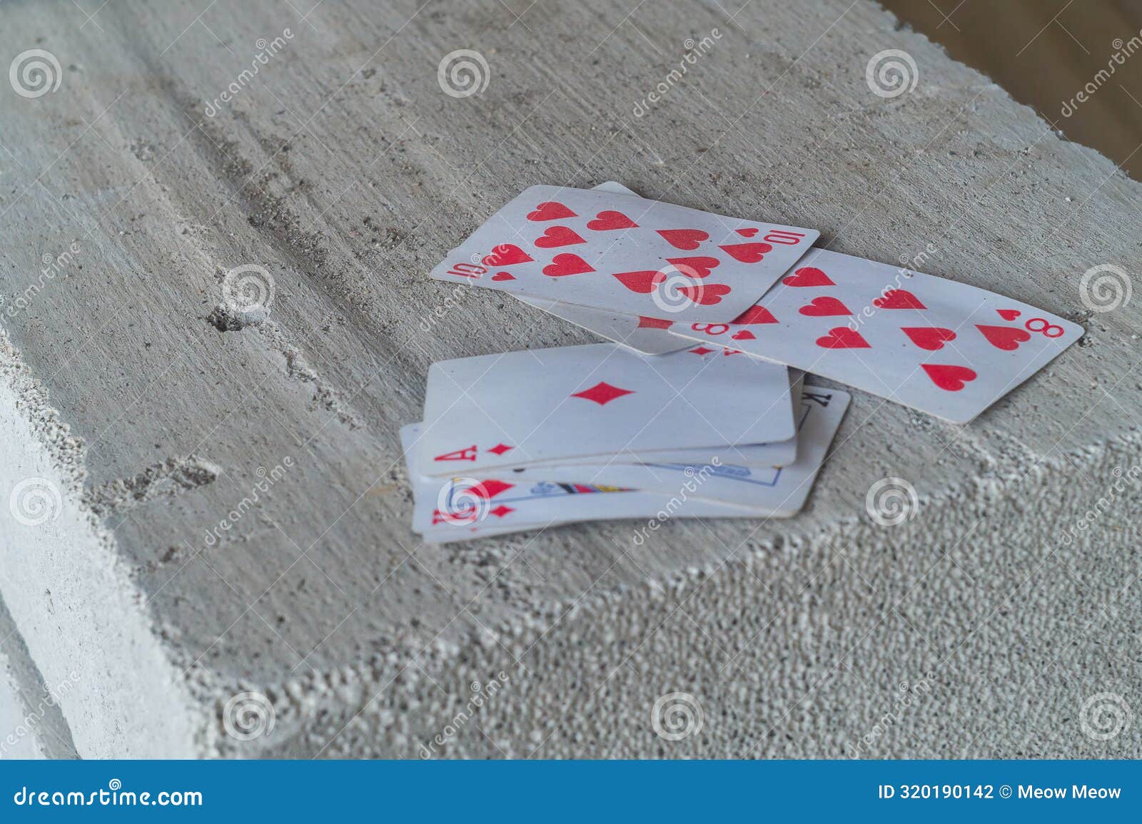 Playing Cards of Red Suits Lie on a Concrete Surface with Roughness ...