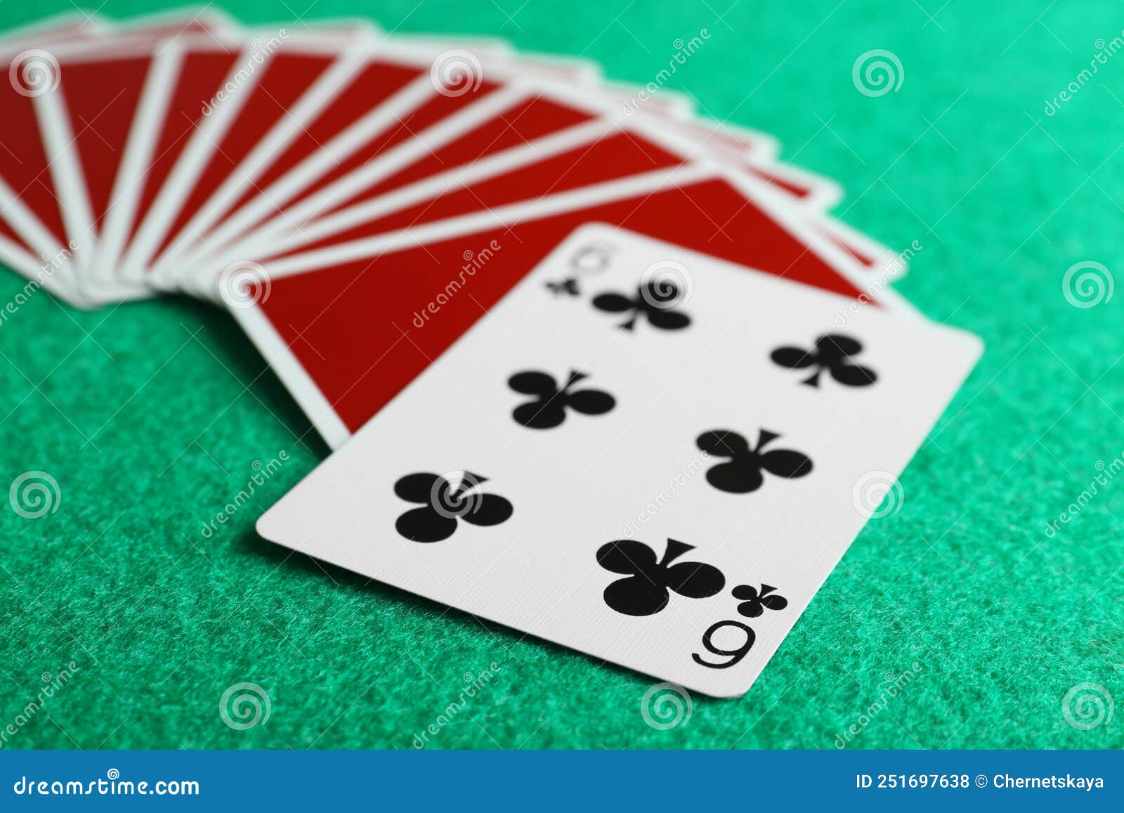 Playing Cards and Six of Clubs on Green Table, Closeup Stock Photo ...