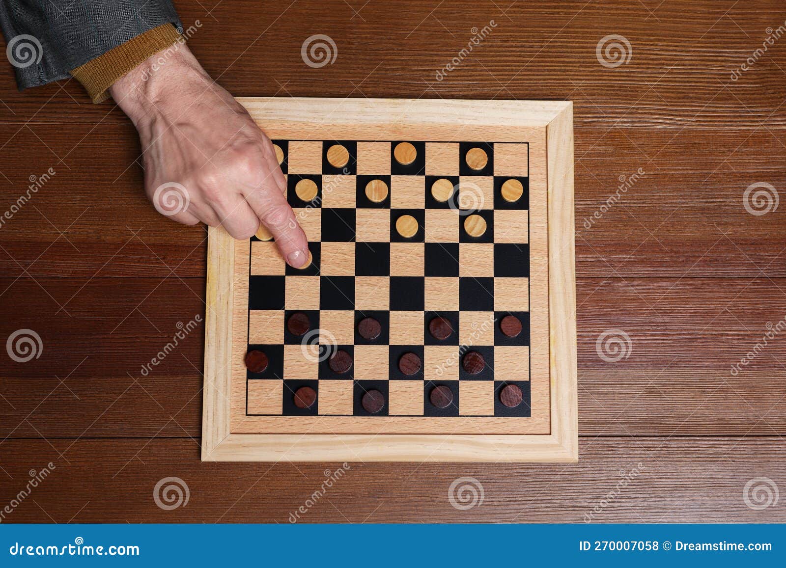 Playing Checkers. Senior Man Thinking about Next Move at Wooden Table ...