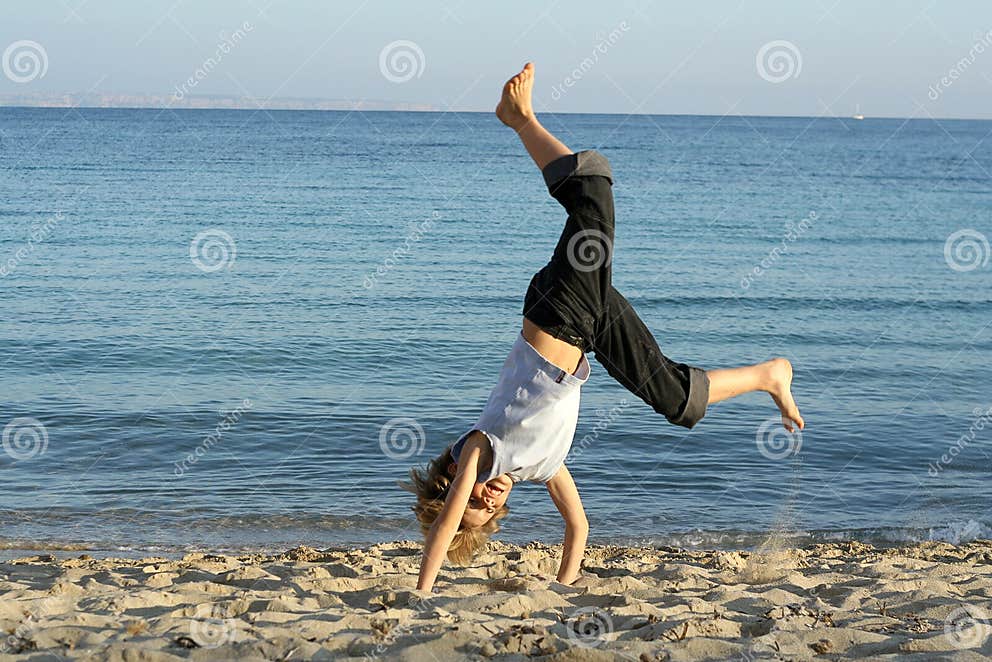 Playing handstand beach stock image. Image of energetic - 501217