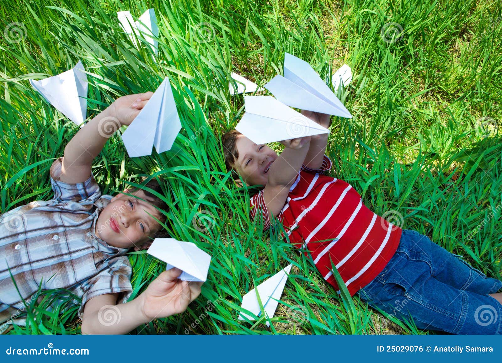 Playing with Paper Planes on Grass Stock Photo - Image of cheerful ...
