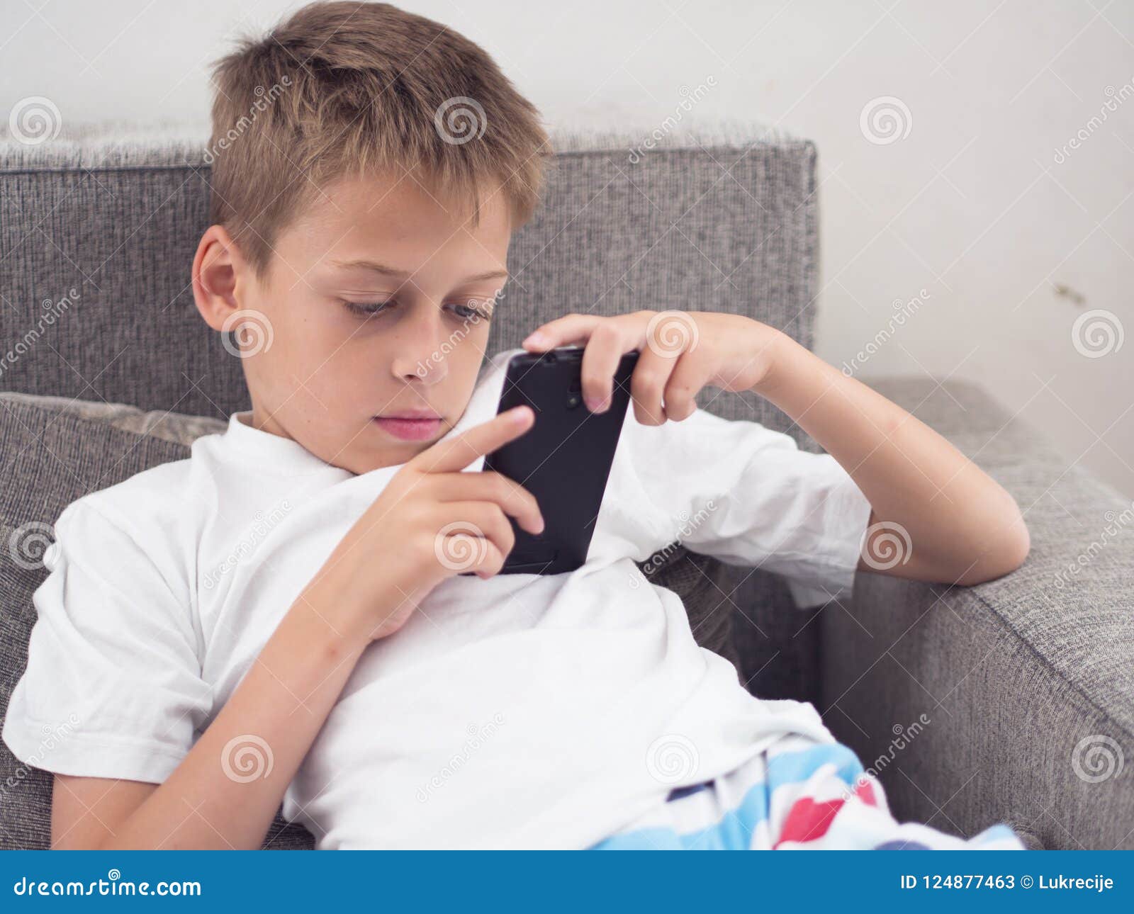 Cute boy with cell phone stock image. Image of smartphone - 124877463