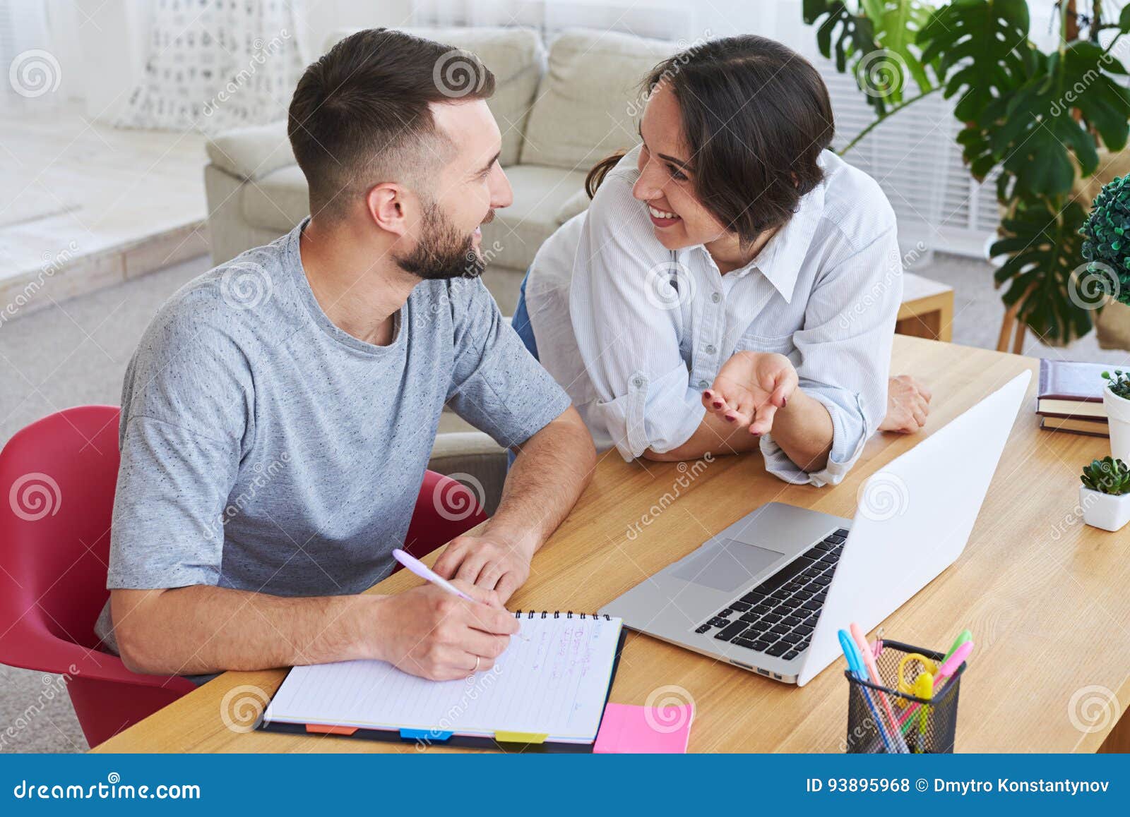 Pleasant Couple Discussing Something and Writing it Down Stock Photo ...