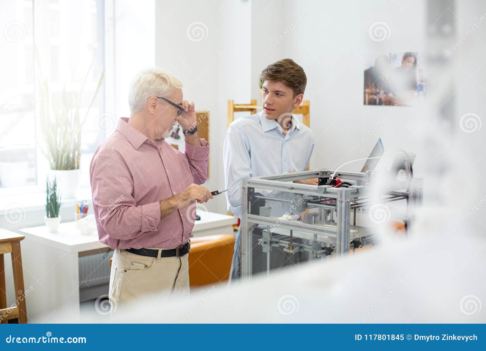 Pleasant Intern Talking with His Supervisor while Printing 3D Models ...