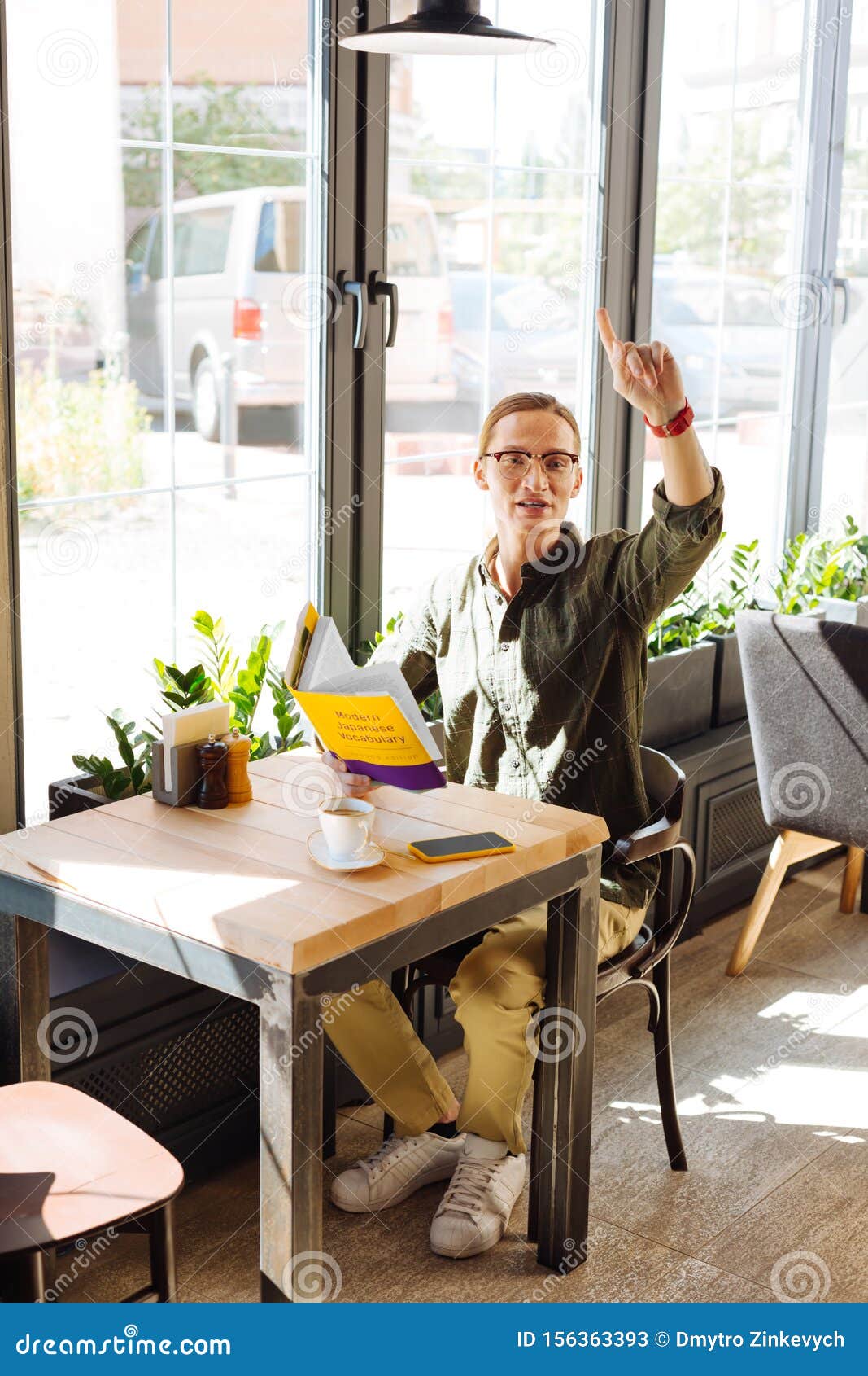 Pleasant Long Haired Man Waiting for the Waiter Stock Image - Image of ...