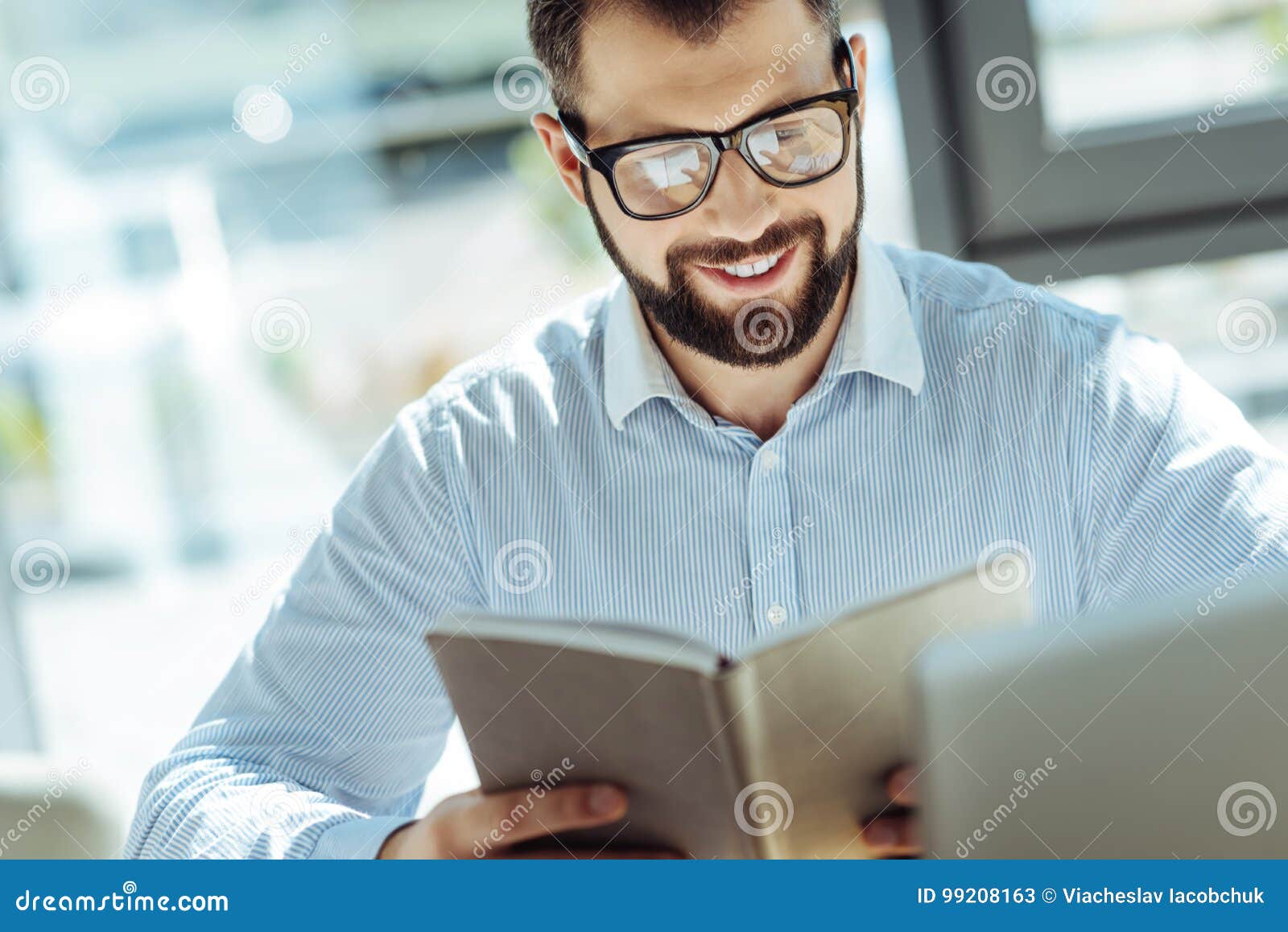 Pleasant Man Looking through His Notes in Notebook Stock Image - Image ...