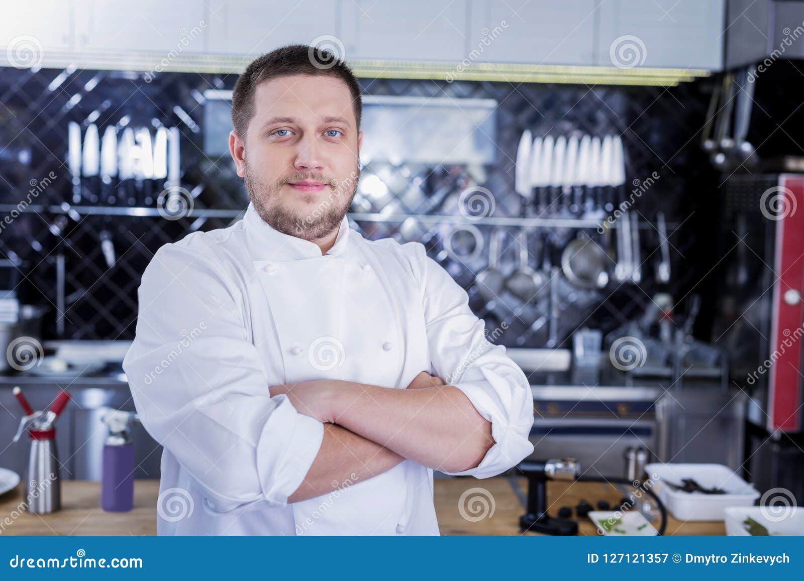 Pleasant Nice Cook Standing in the Middle of the Kitchen Stock Image ...