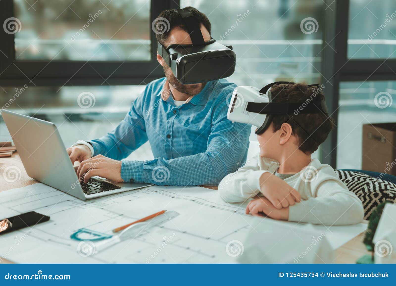 Pleasant Nice Father and Son Using Modern Technology Stock Photo ...