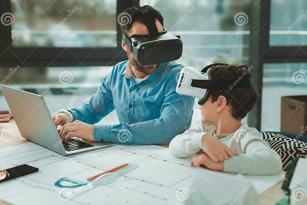 Pleasant Nice Father and Son Using Modern Technology Stock Photo ...