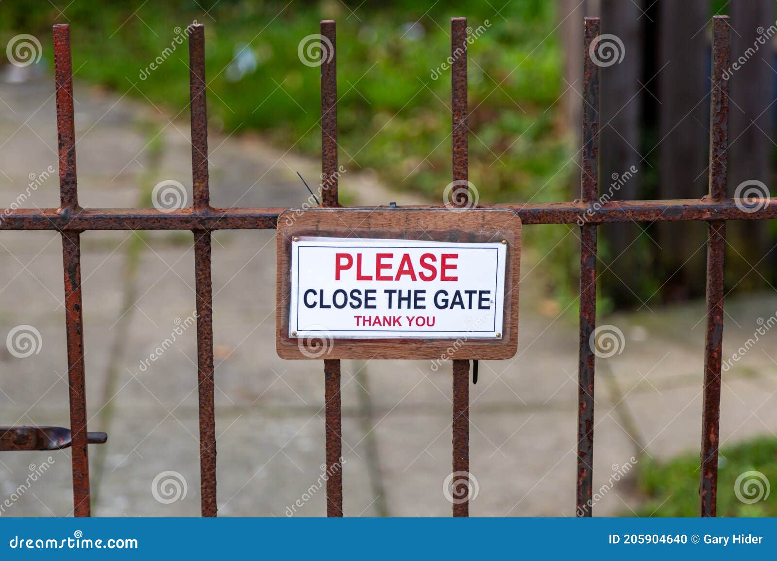 A Please Close the Gate Sign Hanging on a Rusty Metal Gate Stock Photo ...