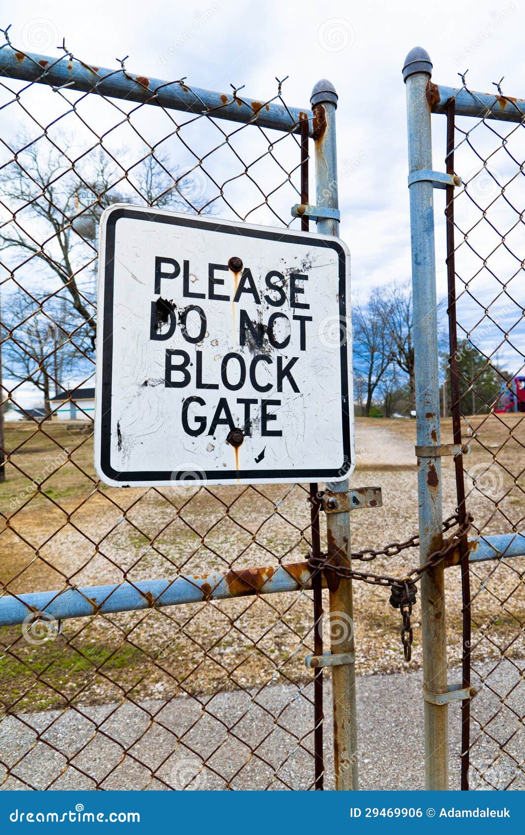 Please Do Not Block Gate Sign Stock Photo - Image of fence, clouds ...