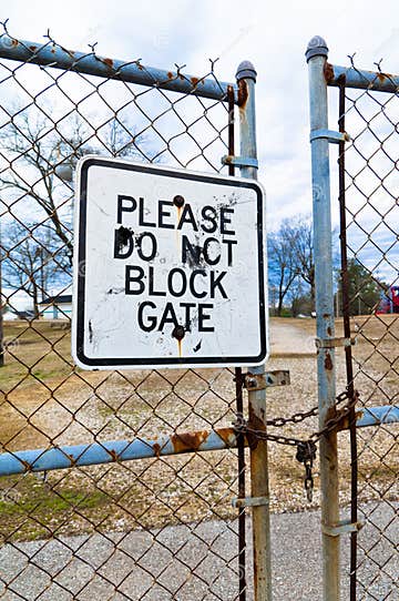 Please Do Not Block Gate Sign Stock Photo - Image of fence, clouds ...