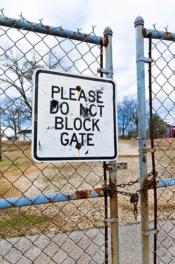 Please Do Not Block Gate Sign Stock Photo - Image of fence, clouds ...