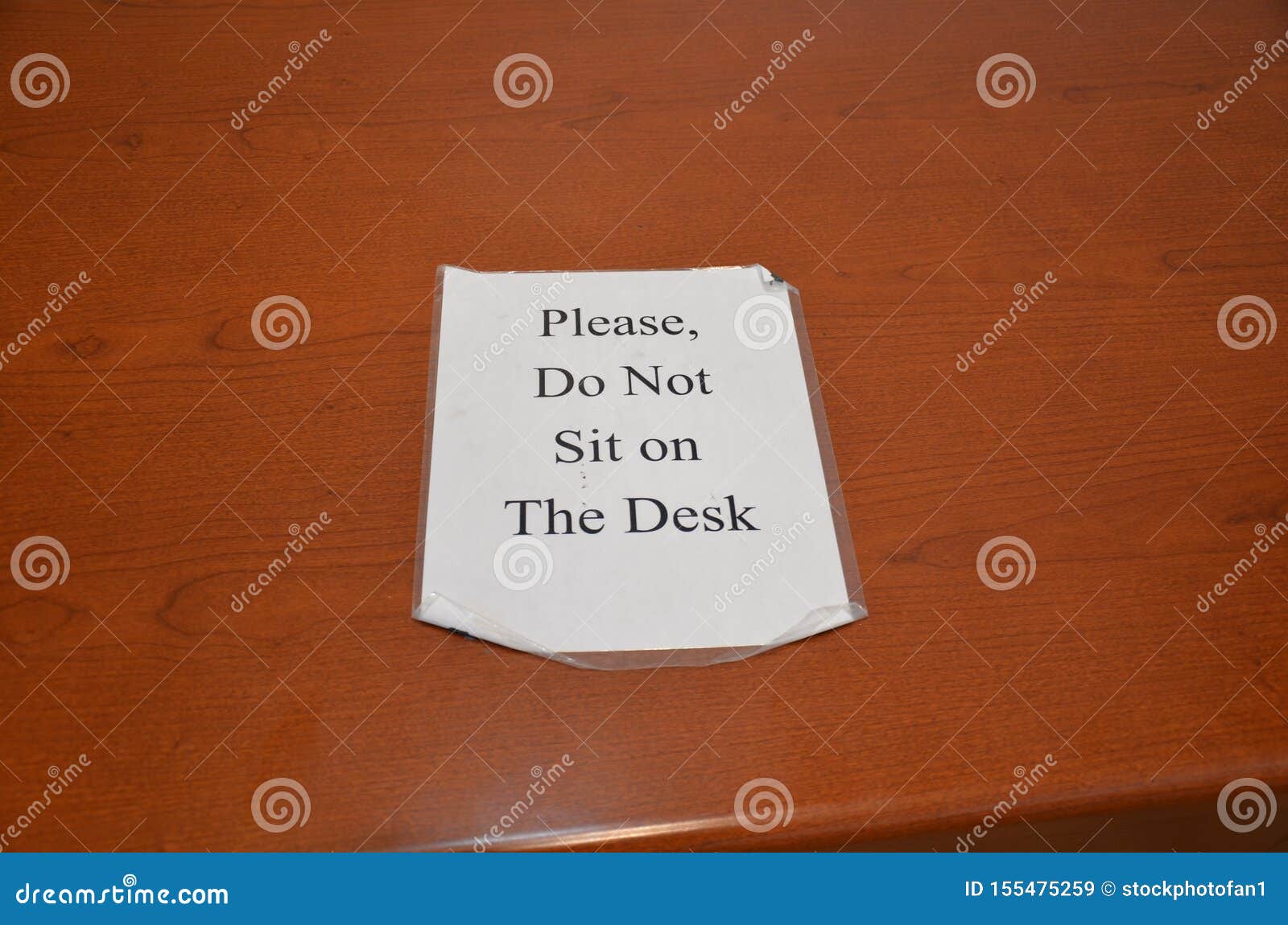 Please Do Not Sit on the Desk Sign on Wood Desk Stock Image - Image of ...