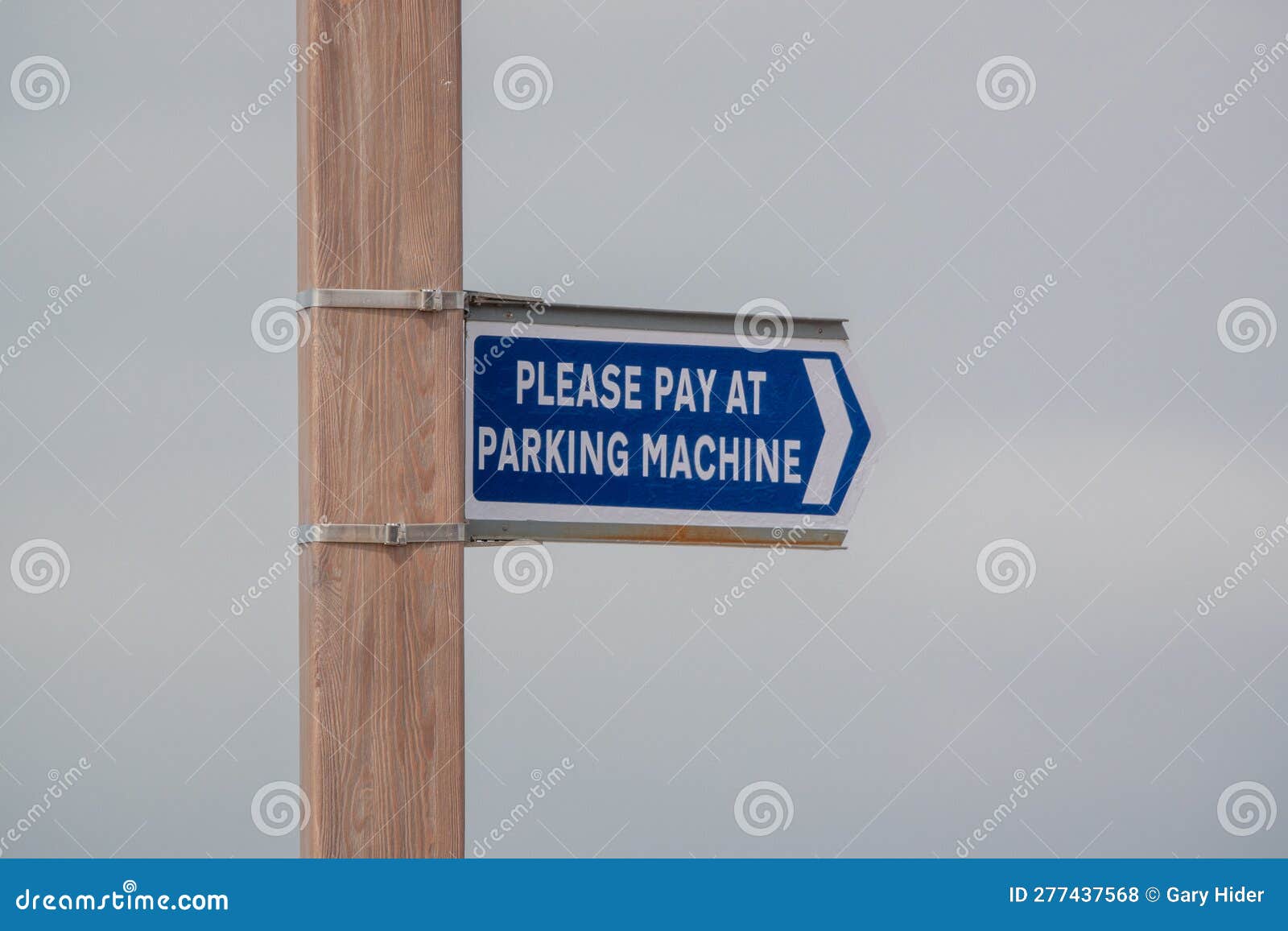 A Please Pay at Parking Machine Sign on a Wooden Post at a Car Park ...
