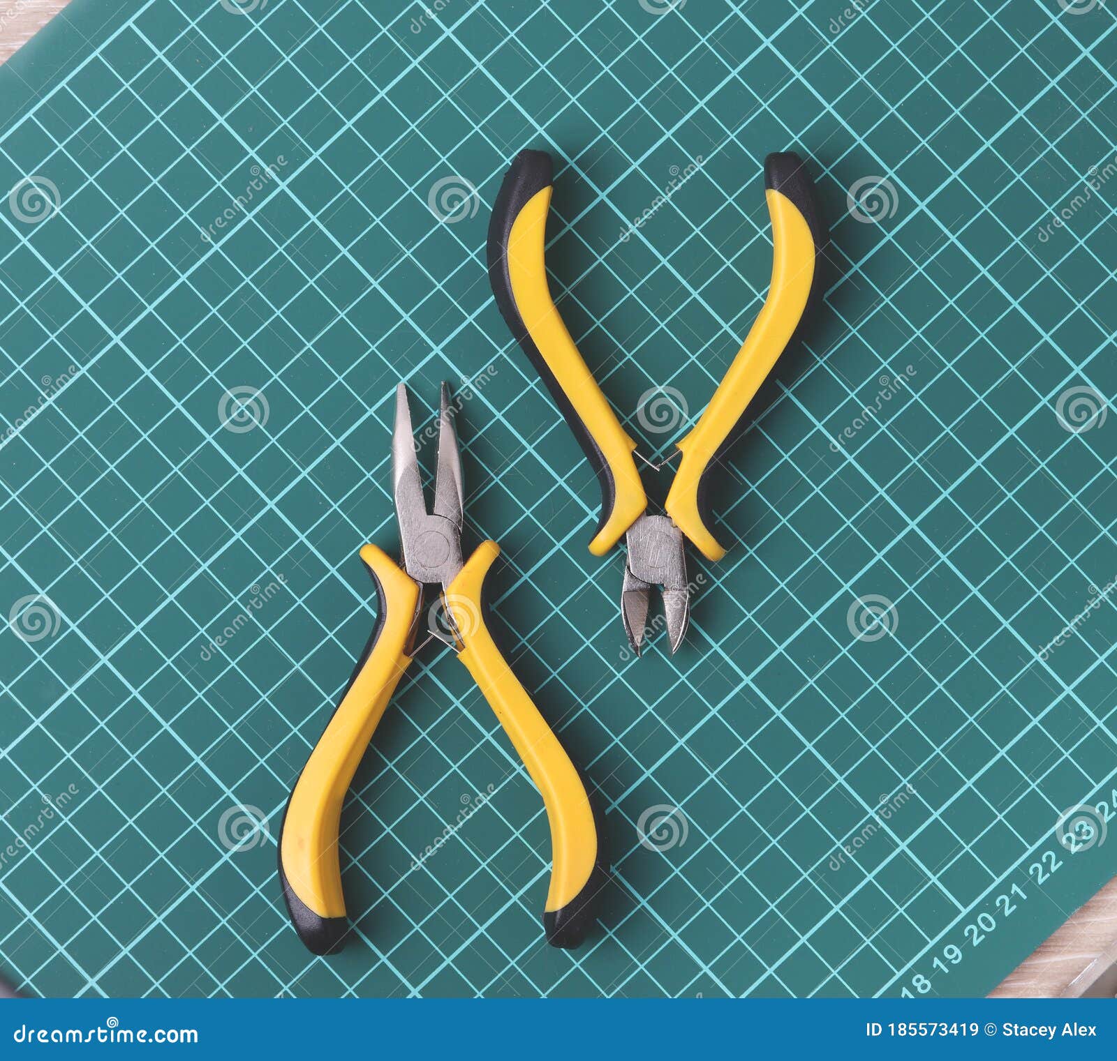 A Plier and a Pincers on Dark Green Grid Mat Stock Image - Image of ...