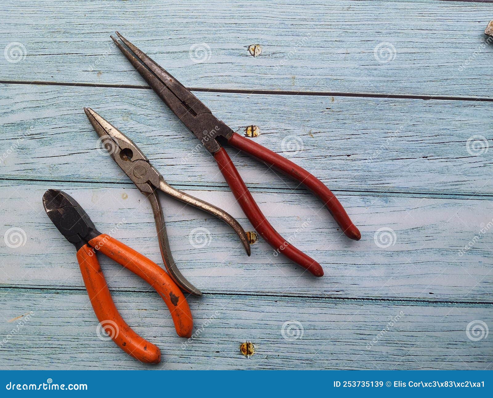 Pliers, Three Different Types of Pliers, on a Wooden Table, Top View ... Pliers, Three Different Types of Pliers, on a Wooden Table, Top View ...