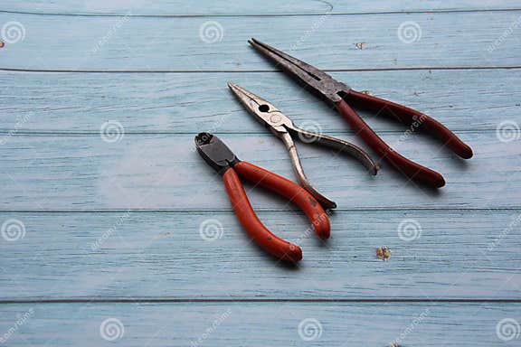 Pliers, Three Different Types of Pliers, on a Wooden Table, Top View ... Pliers, Three Different Types of Pliers, on a Wooden Table, Top View ...