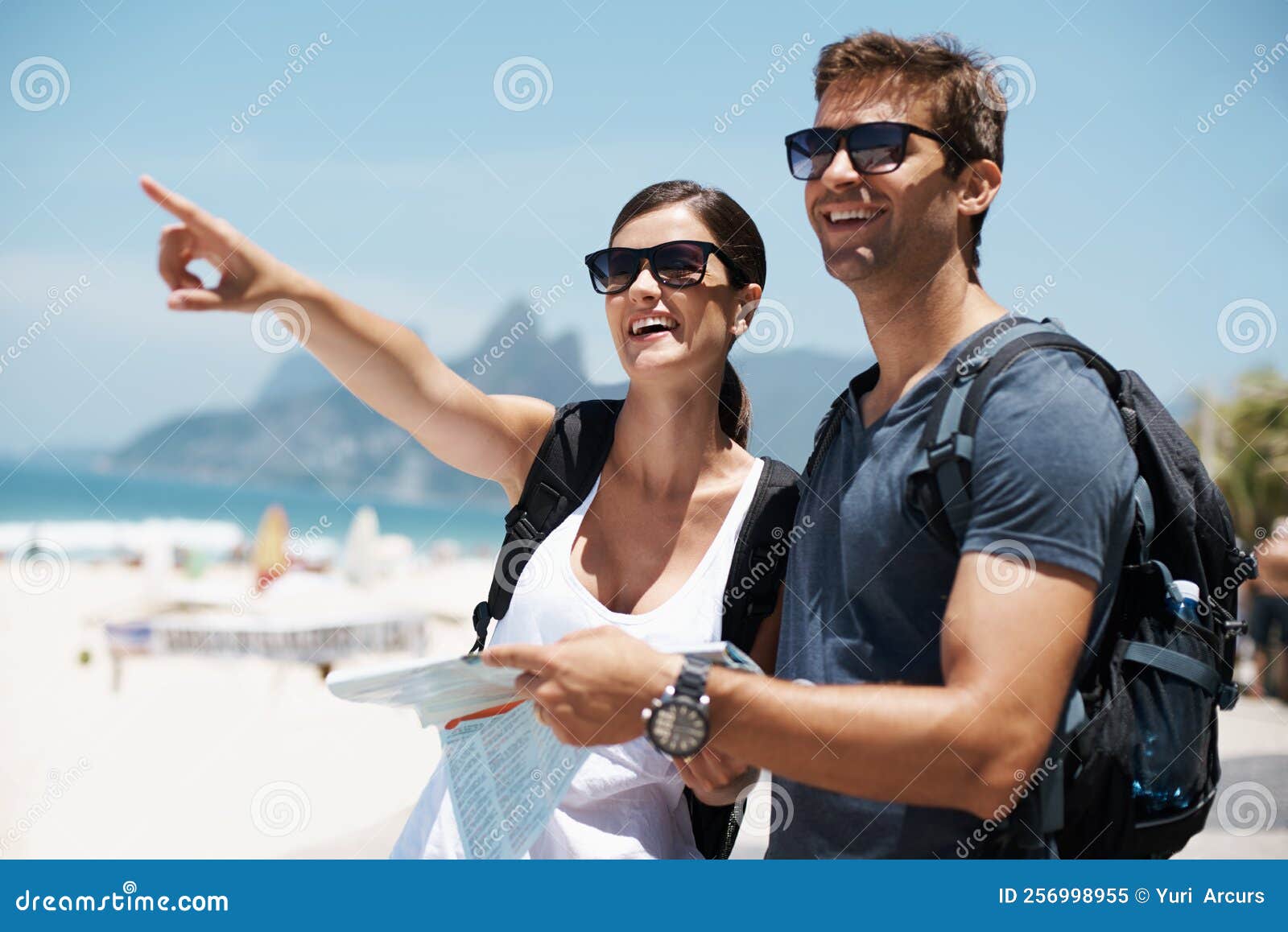 Plotting a Route To the Sights. a Young Couple Holding a Map and ...