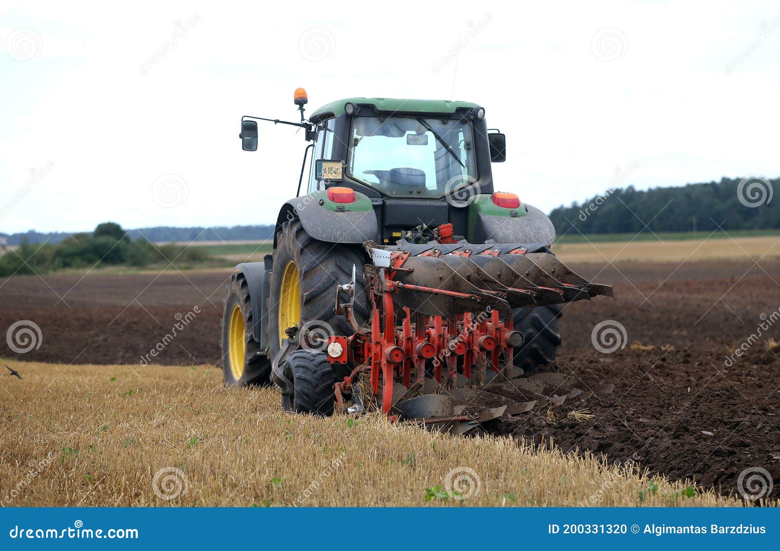 Ploughing Tractor At Field Cultivation Work. Machine Plows The Field ...