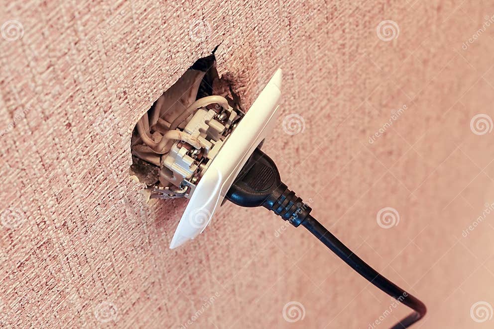 Plug in a Broken Outlet, Risk of Electric Shock Stock Photo - Image of ...