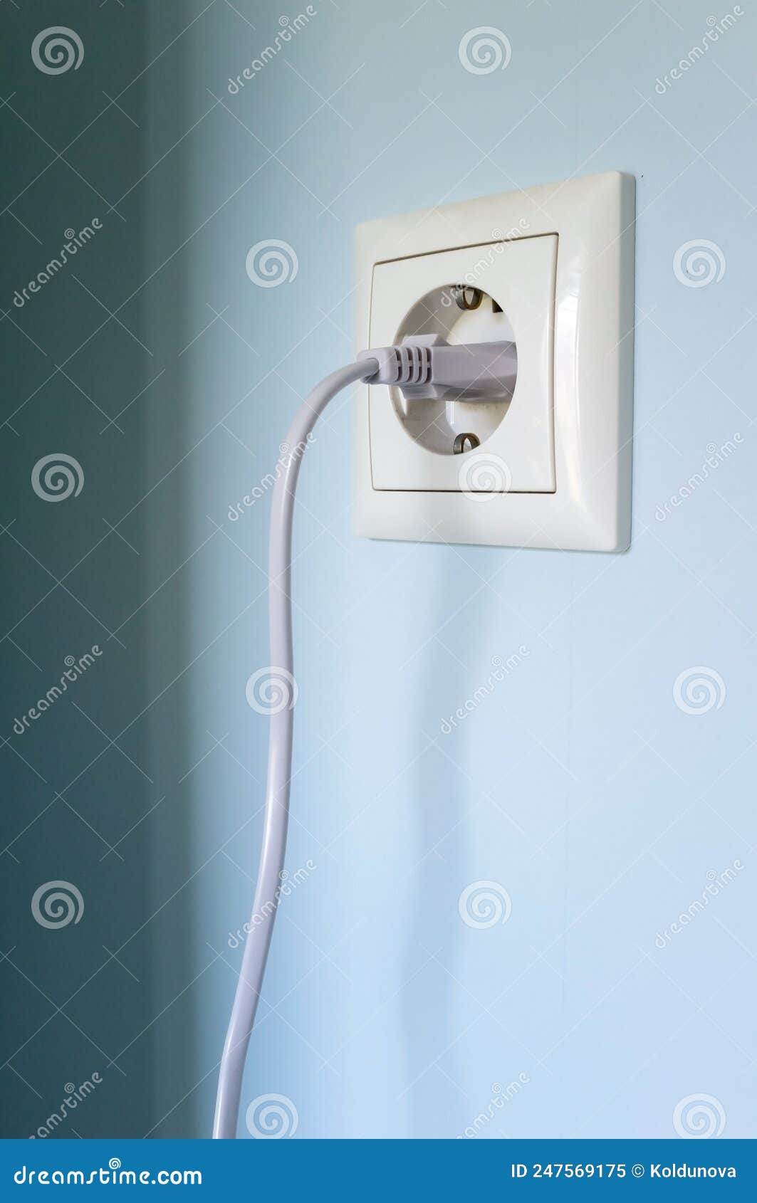 Plug with Cable Cord Connected To the Socket, on a Blue Wall. Stock ...