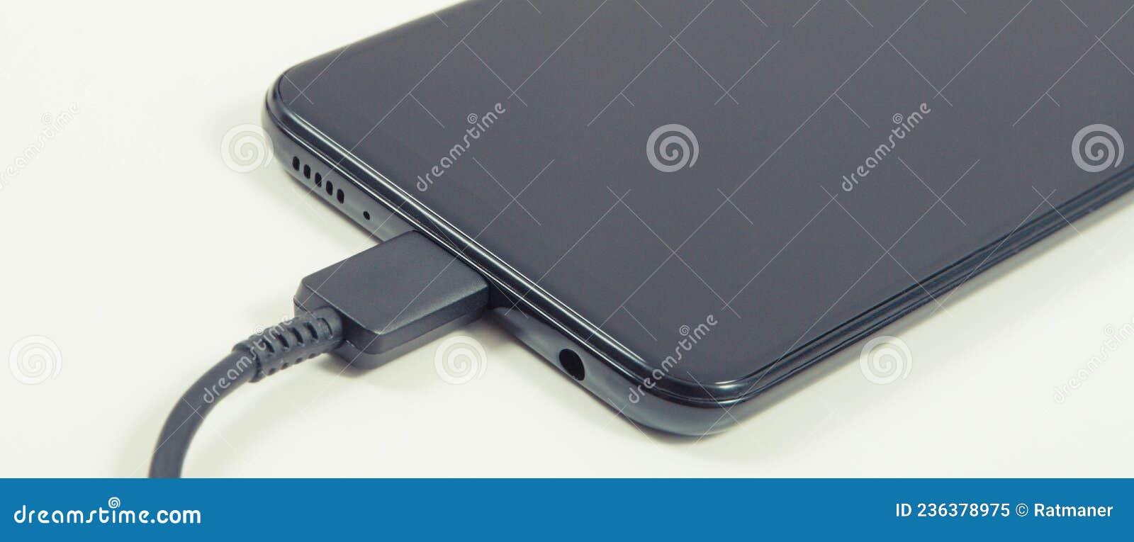 Plug of Charger Connected To Black Mobile Phone. Smartphone Charging ...