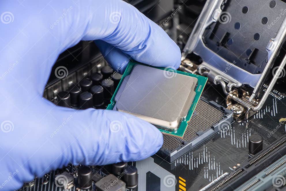 Plug in CPU Microprocessor To Motherboard Socket. Technological ...