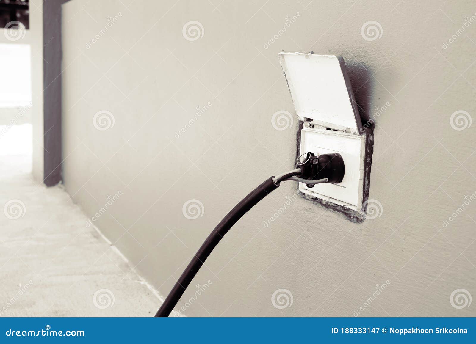 The Plug is Plugged into a Wall Outlet at Outside of House Stock Image ...