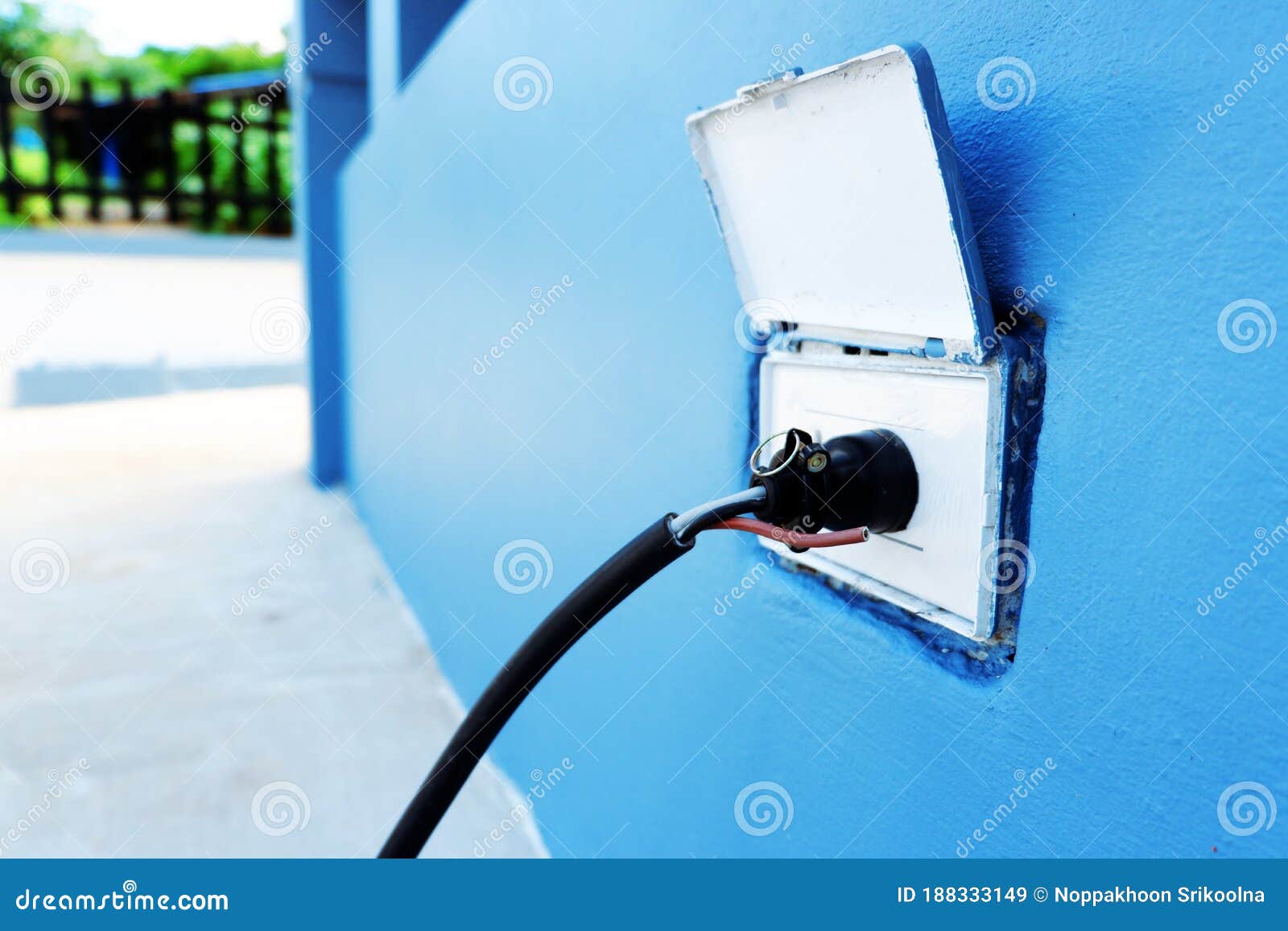 The Plug is Plugged into a Wall Outlet at Outside of House Stock Image ...