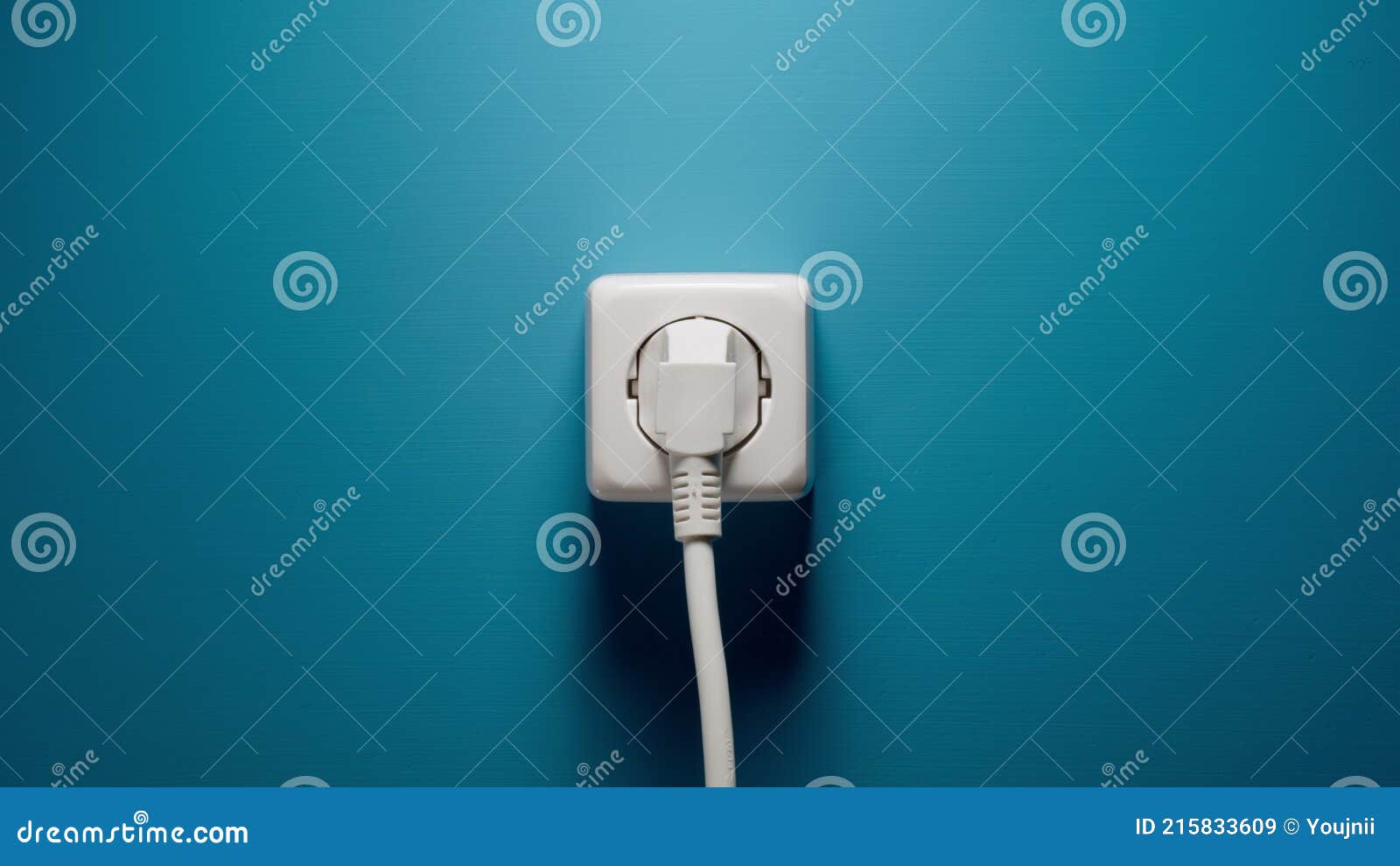 Plugged into an Electrical Outlet on a Blue Wall Stock Image - Image of ...
