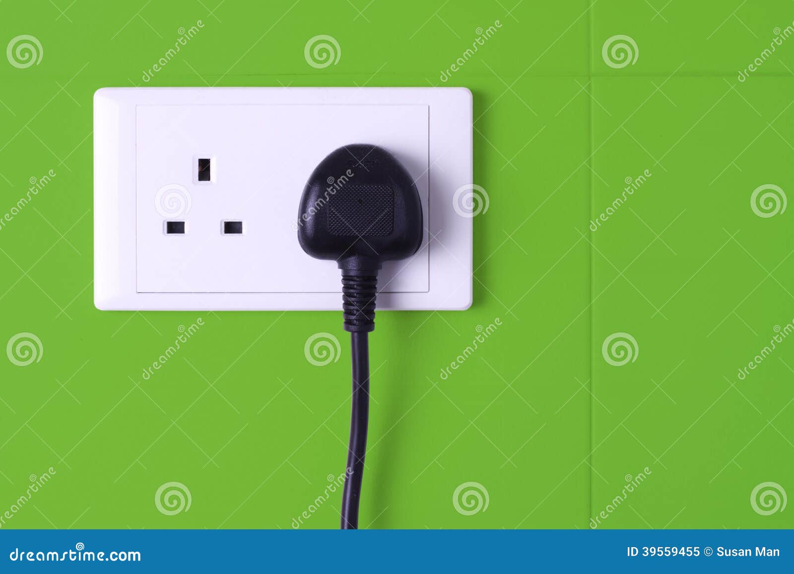 Plugged in Socket Against Green Tiles Background Stock Image - Image of ...