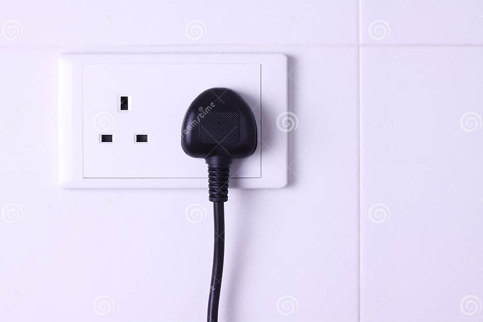 Plugged in Socket Against White Tiles Background Stock Image - Image of ...