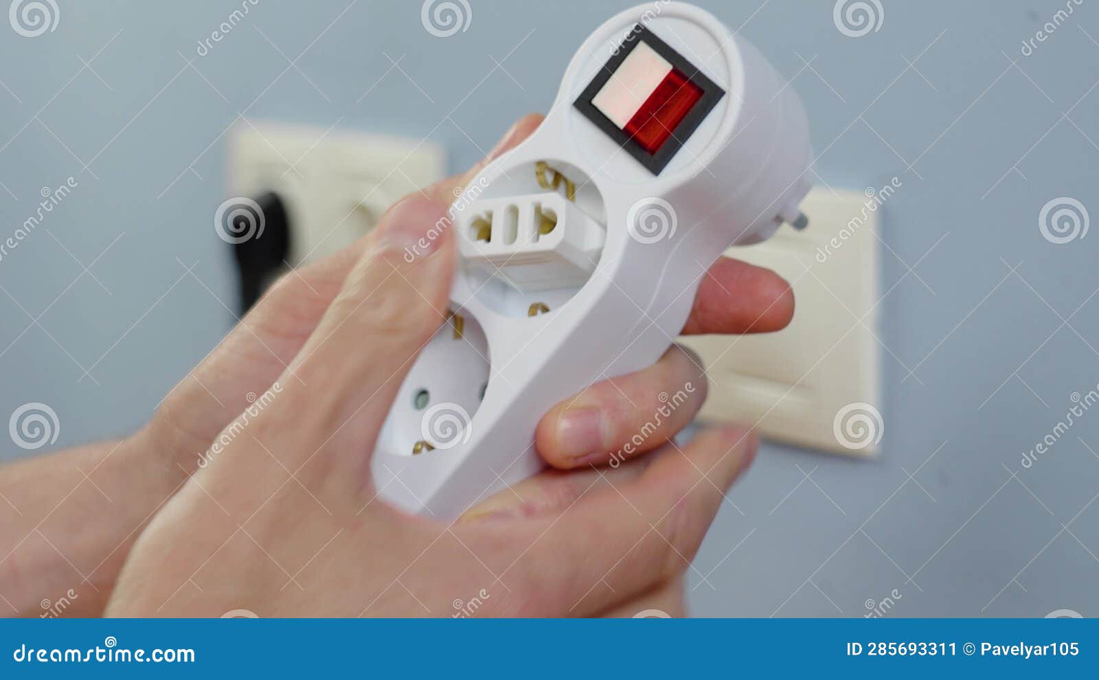 Plugging in an Electrical Adapter To an Electric Splitter with Red ...