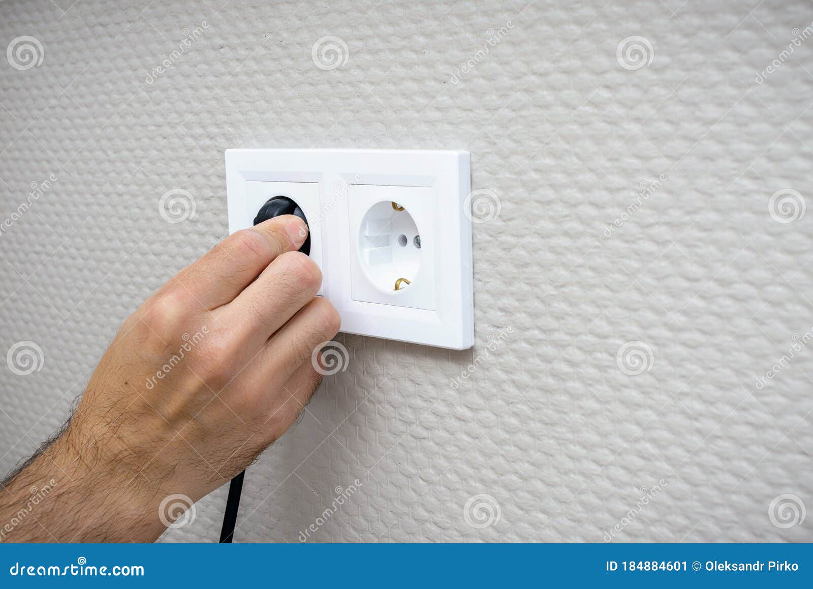 Plugging Electrical, Black Plug in White Electric Socket on Wall. Stock ...