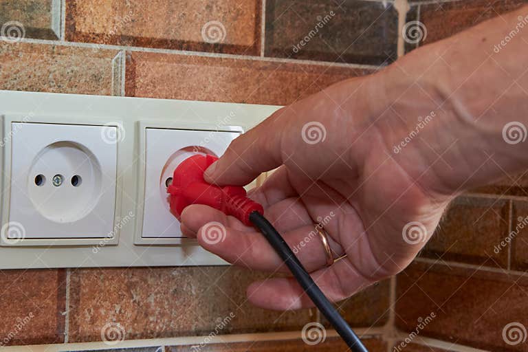 Plugging Plug from the Outlet,male Hands Pull Out the Plug from the ...